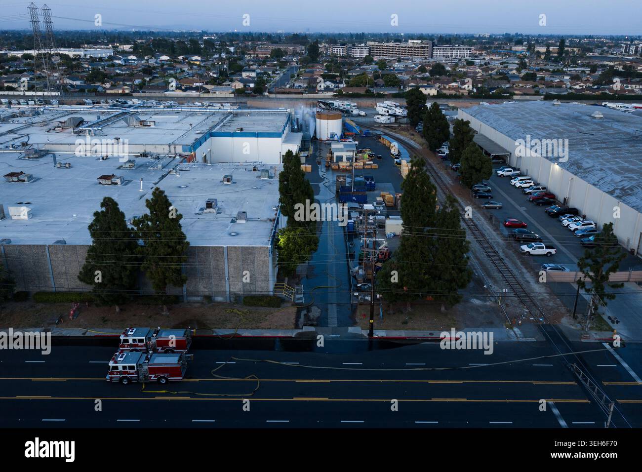 Water is sprayed on a tank that overheated at an aerospace plant in ...