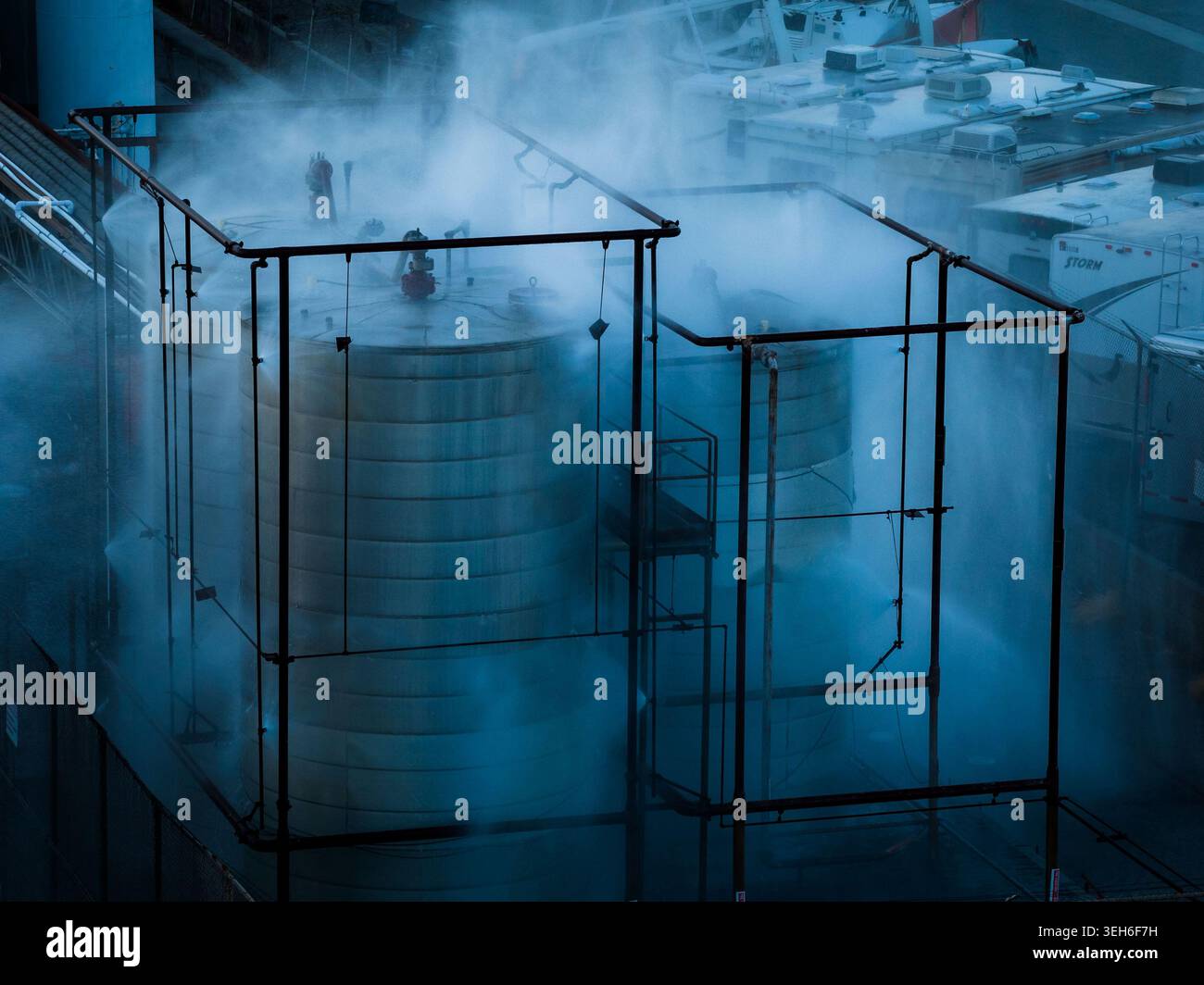 Water is sprayed on a tank that overheated at an aerospace plant in ...