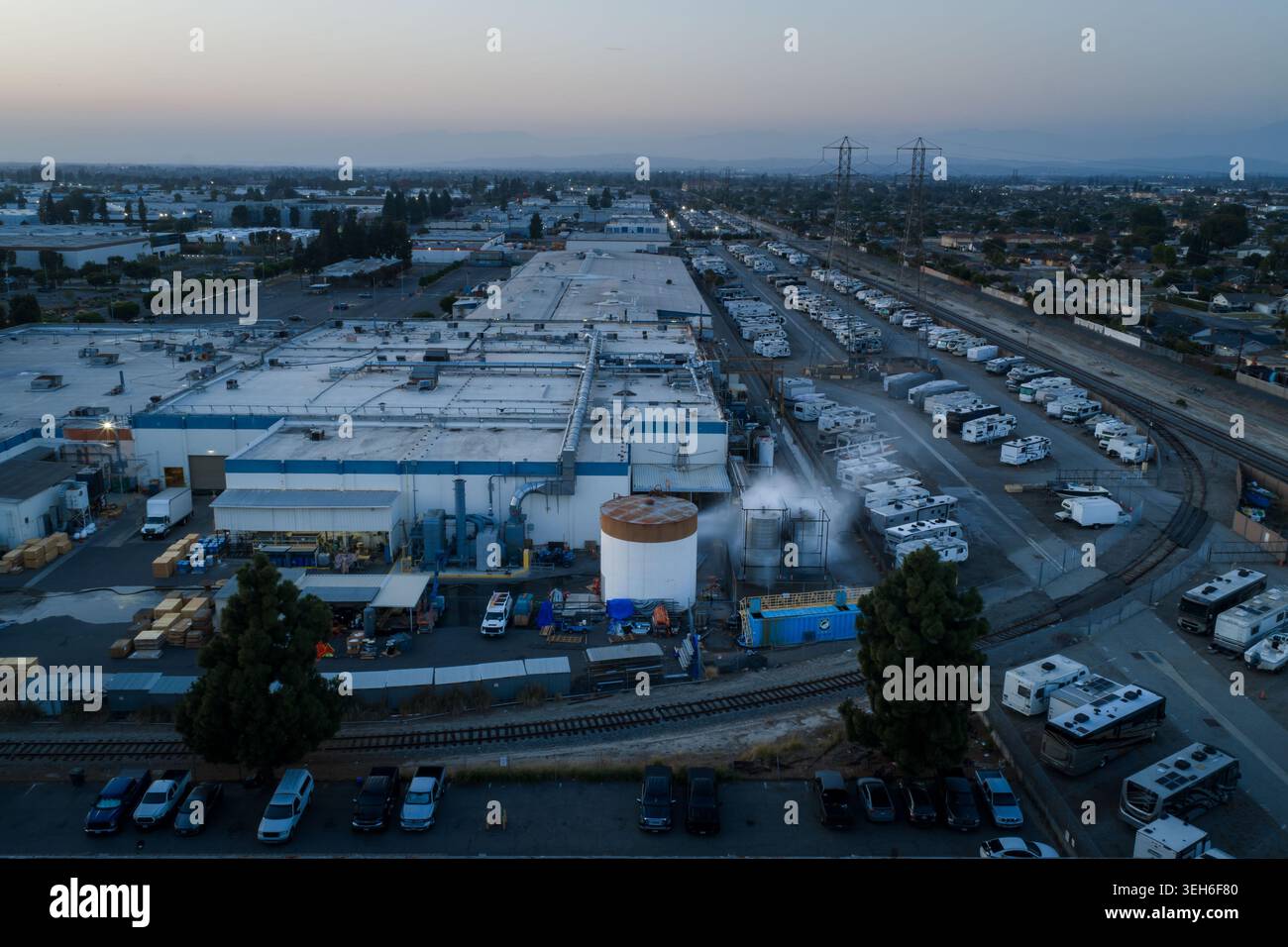 Water is sprayed on a tank that overheated at an aerospace plant in ...
