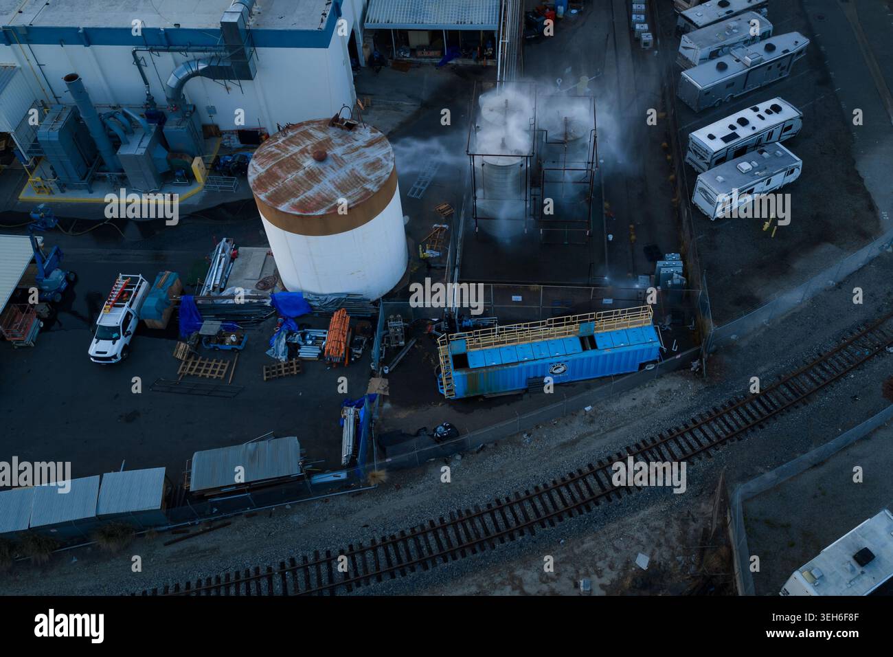 Water is sprayed on a tank that overheated at an aerospace plant in ...