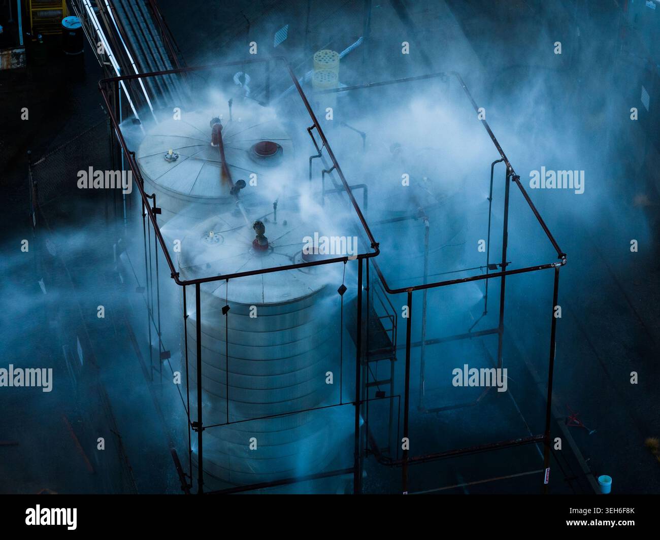 Water is sprayed on a tank that overheated at an aerospace plant in ...