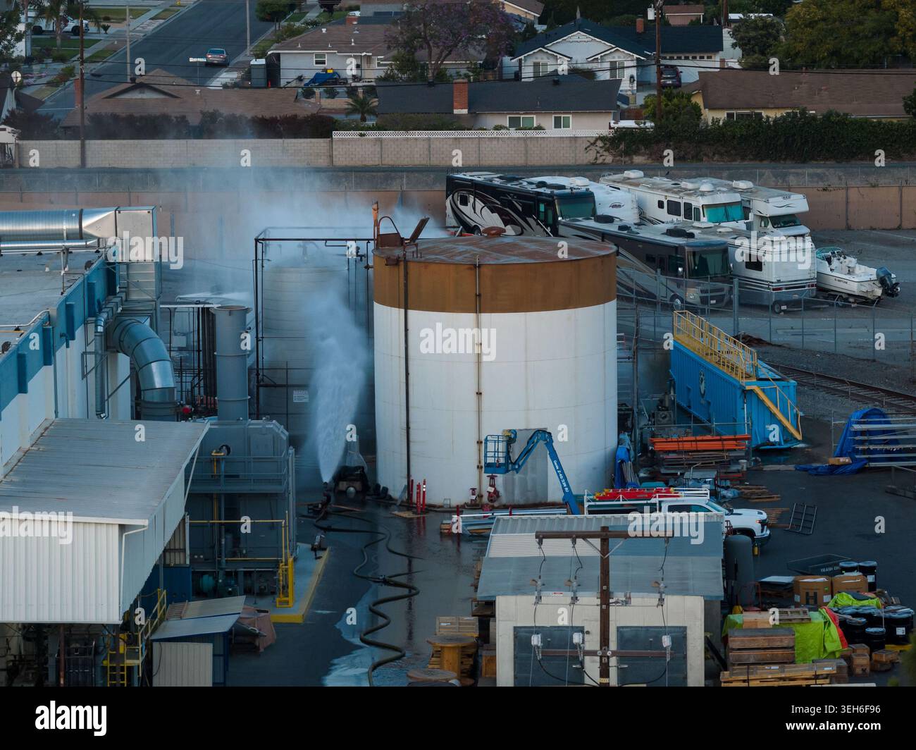 Water is sprayed on a tank that overheated at an aerospace plant in ...