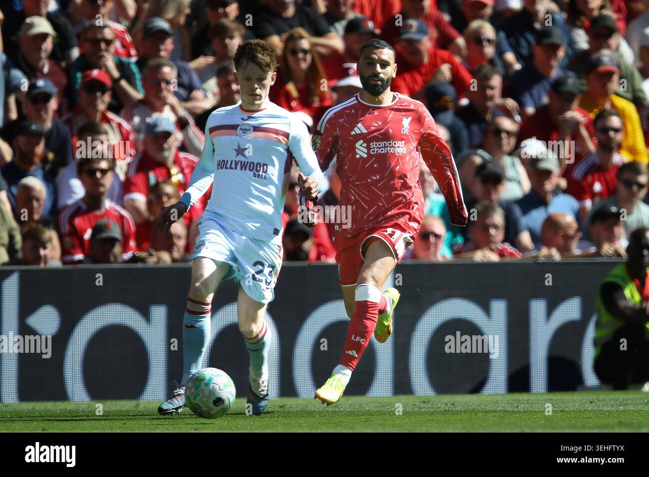 Keane Lewis-Potter of Brentford shields the ball from Mohamed Salah of ...