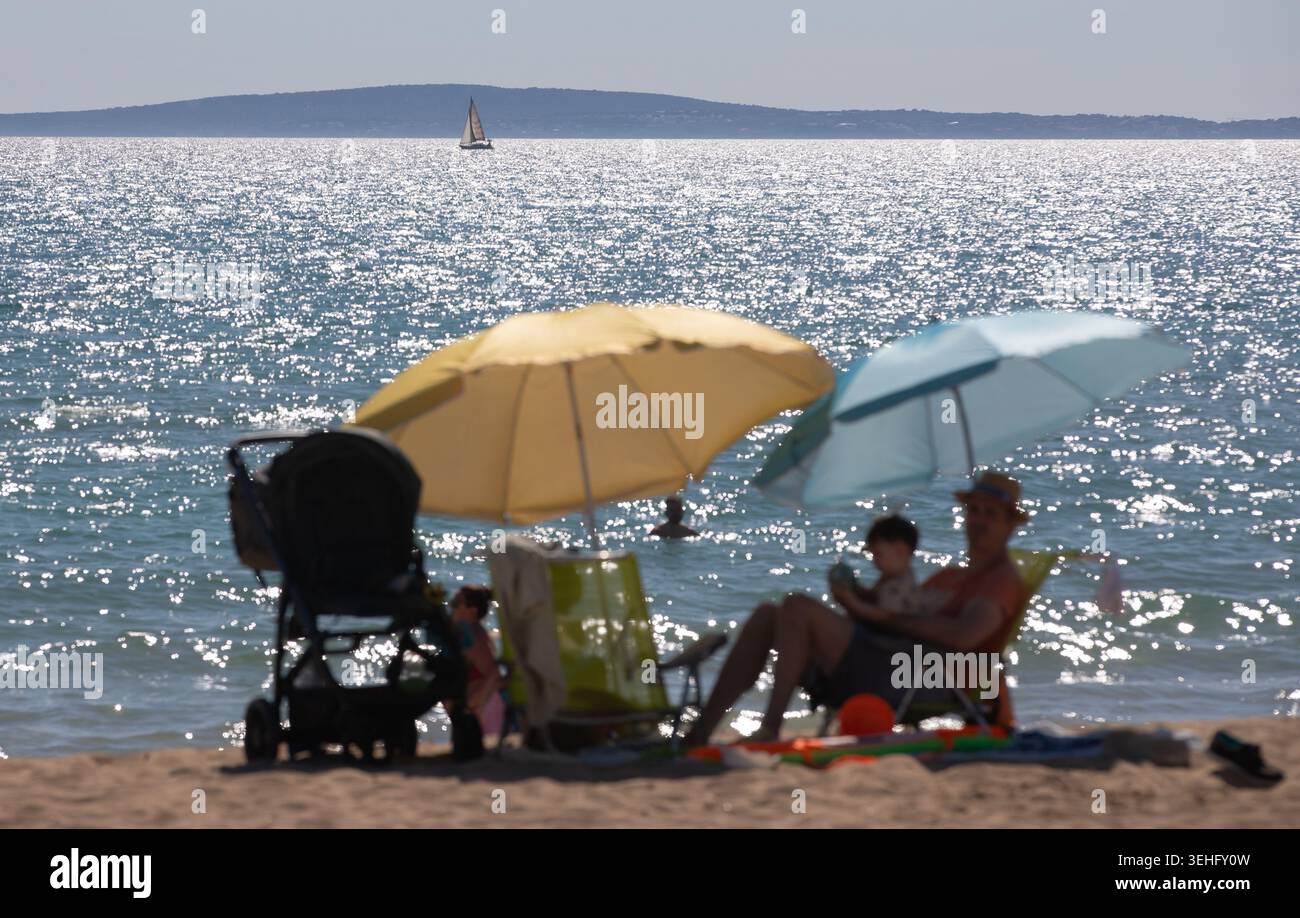 24 May 2026, Spain, Palma: People sunbathe and swim at Playa de Palma ...