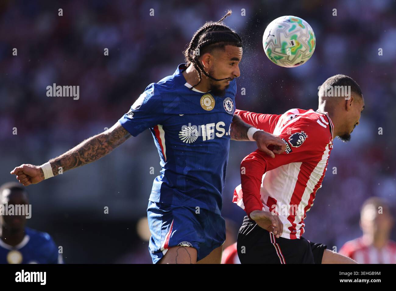 Malo Gusto of Chelsea wins a header against Wilson Isidor Of Sunderland ...