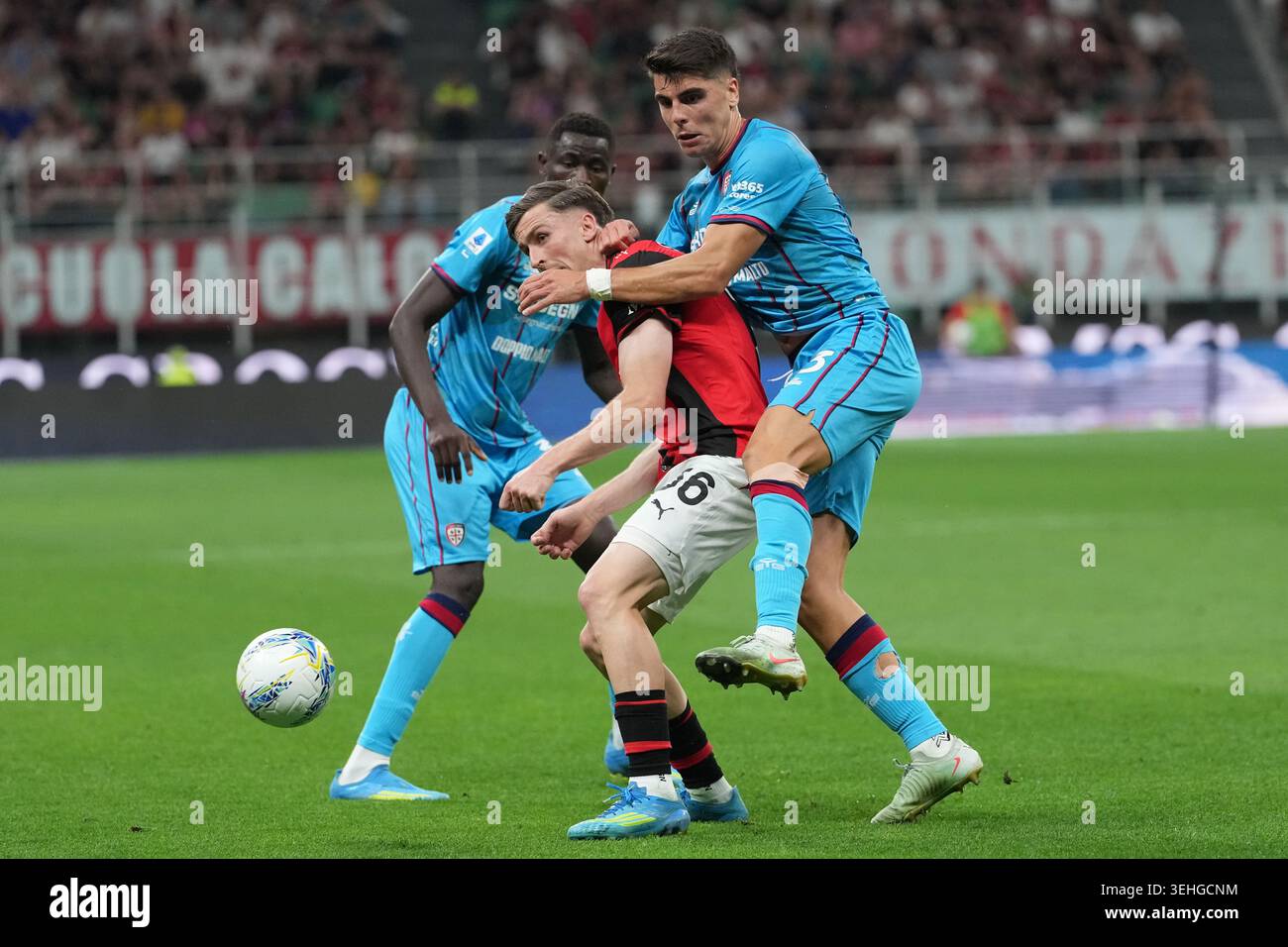 AC Milan's Alexis Saelemaekers, left, challenges for the ball with ...
