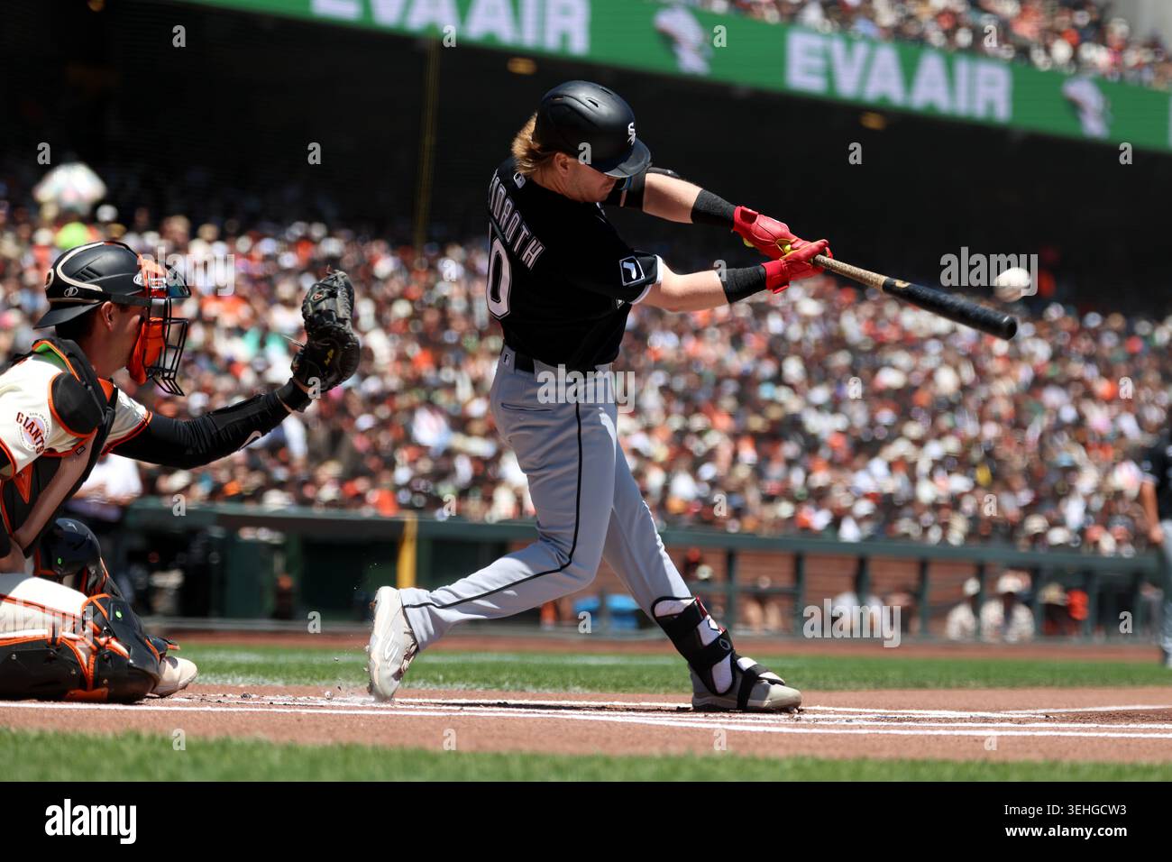 Chicago White Sox' Chase Meidroth, right, hits a home run in front of ...