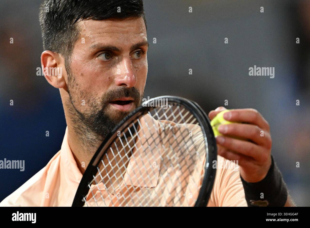 Novak Djokovic of Serbia serves to Giovanni Mpetshi Perricard of France ...