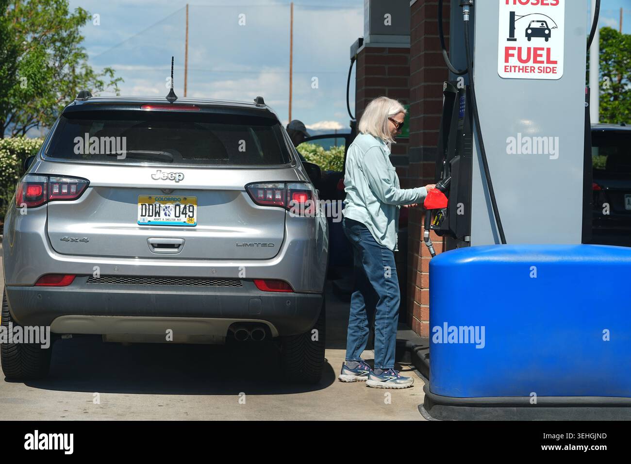 A motorist swipes a credit card at the pump to pay for gasoline at a ...