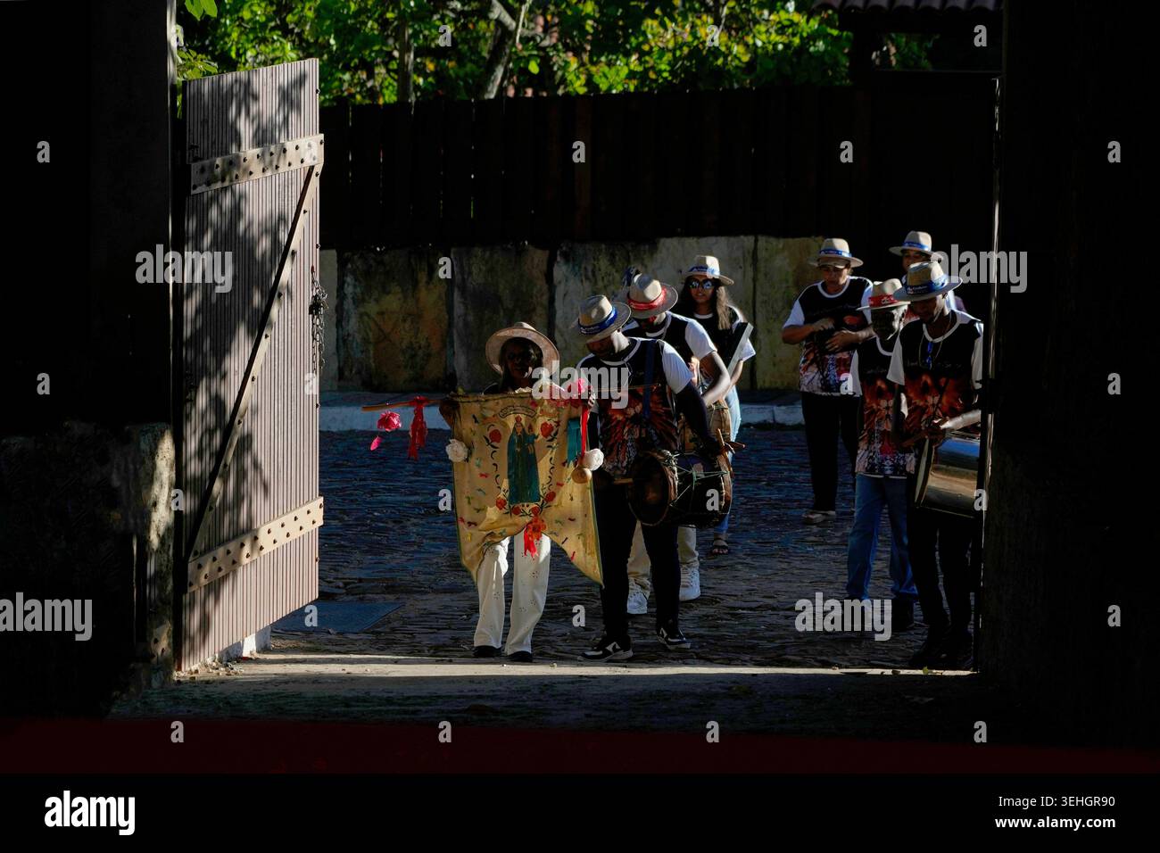 Members of a congada group arrive at a procession during the Holy ...