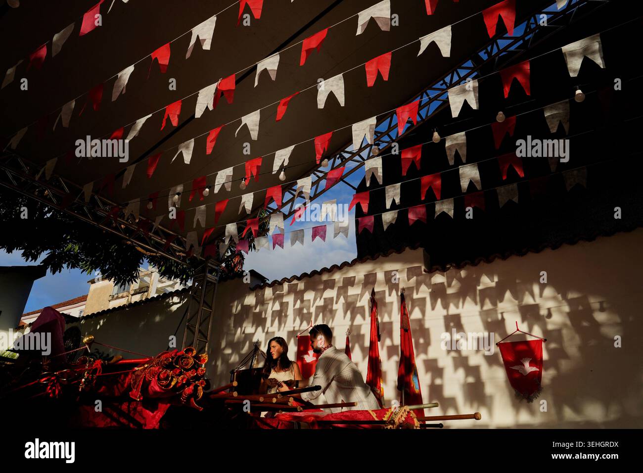 Revelers get ready for a procession held during the Holy Spirit ...