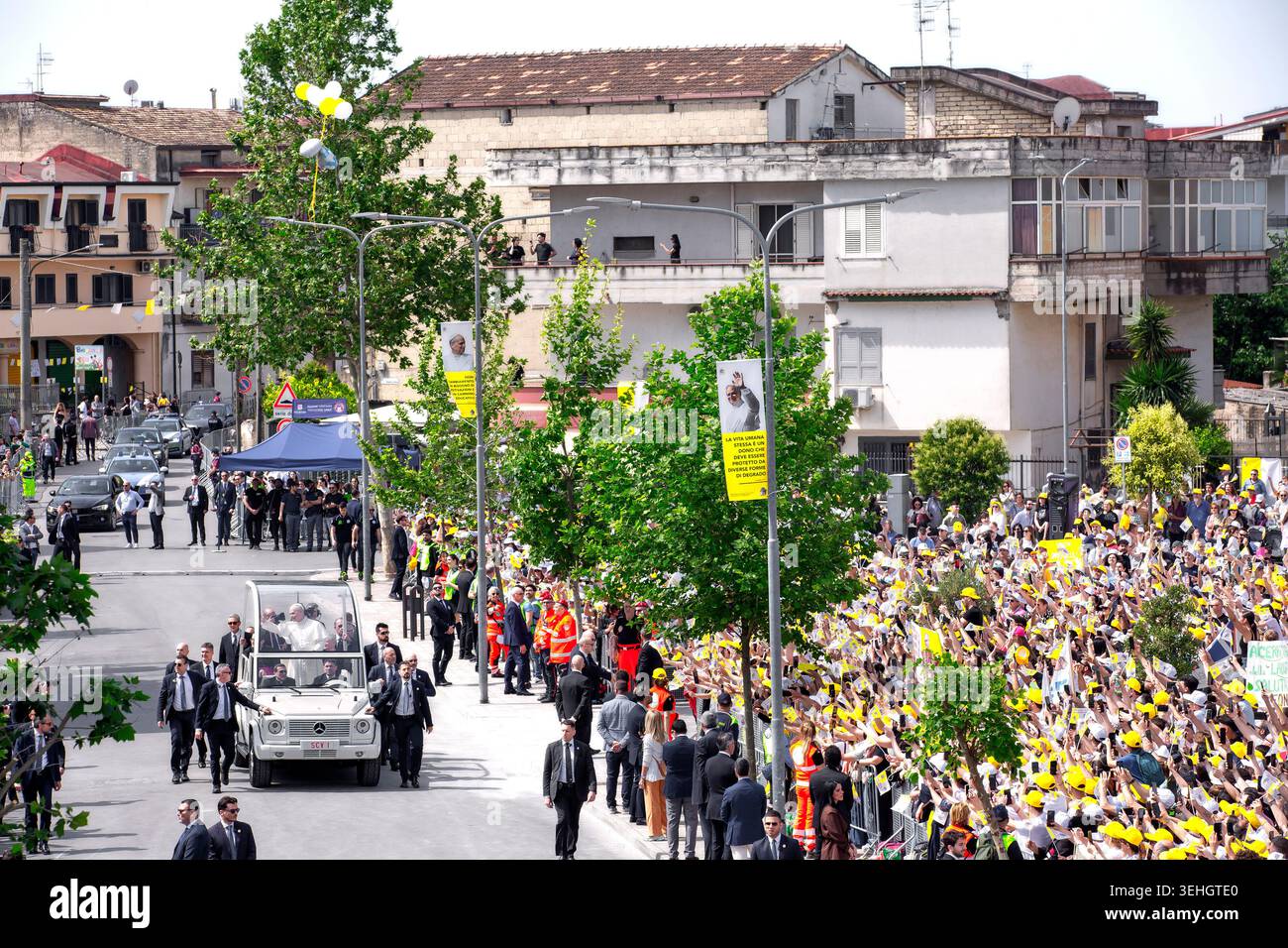 Pope Leo XIV waves as he arrives on the popemobile at Piazza Calipari ...