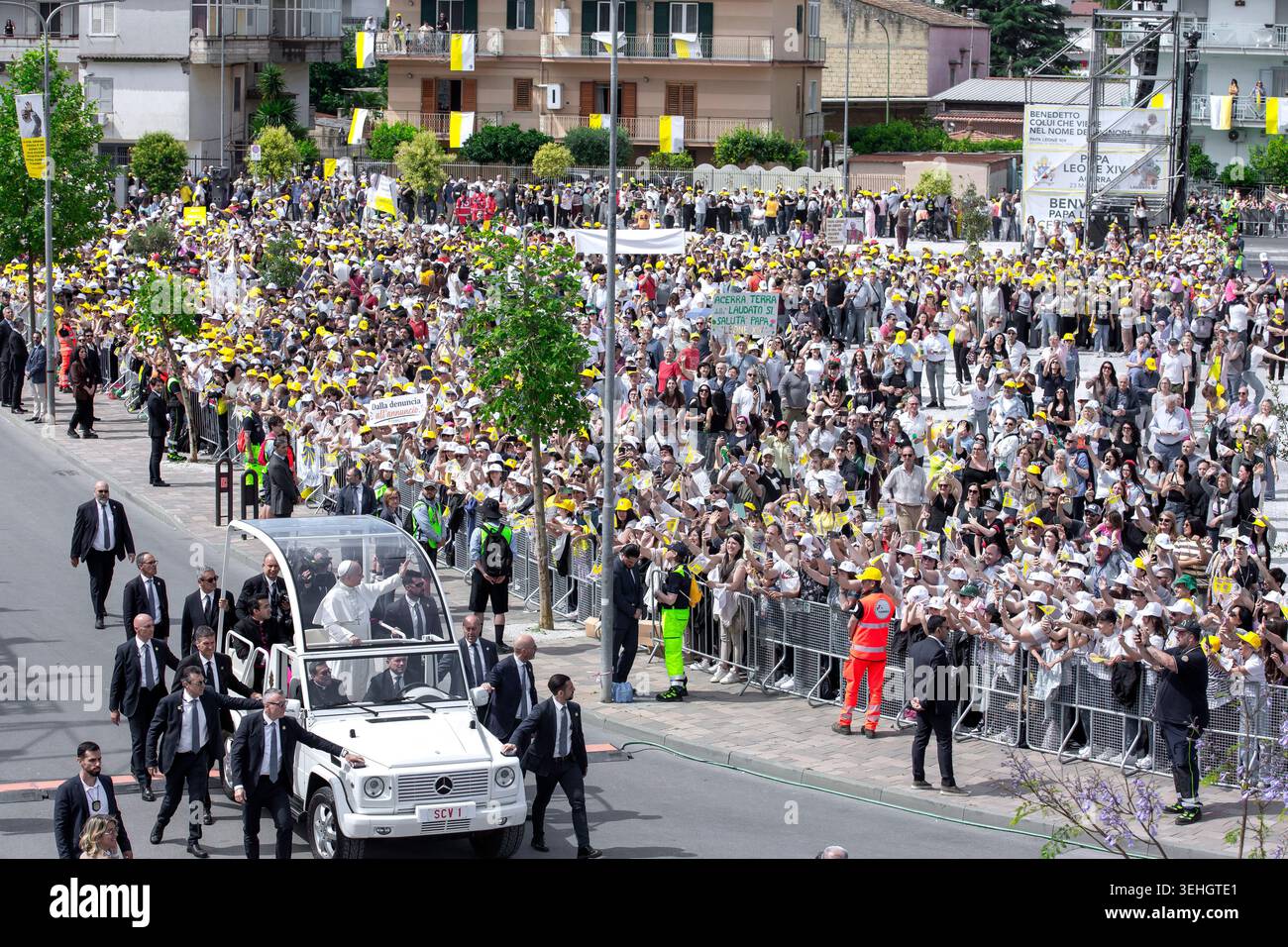 Pope Leo XIV waves as he arrives on the popemobile at Piazza Calipari ...