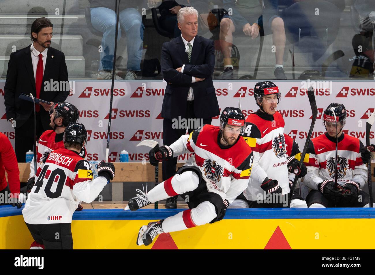 Roger Bader, head coach of Austria, background center, during the men's ...