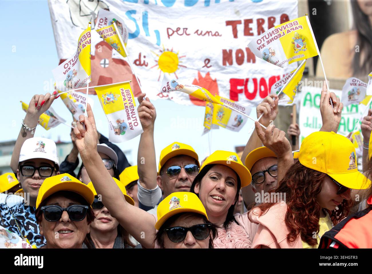 People wait for Pope Leo XIV's arrival in Calipari Square during his ...