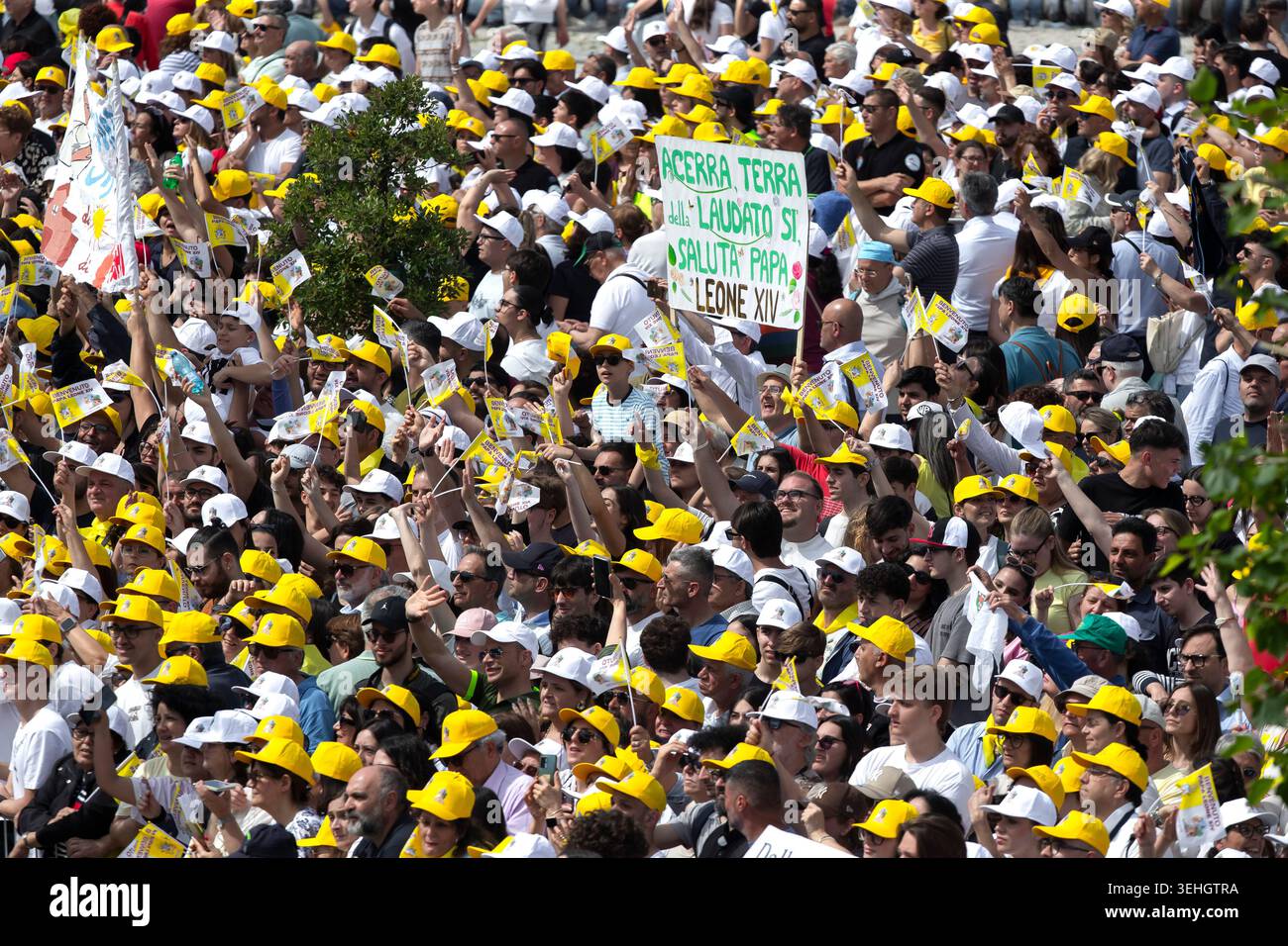 People wait for Pope Leo XIV's arrival in Calipari Square during his ...