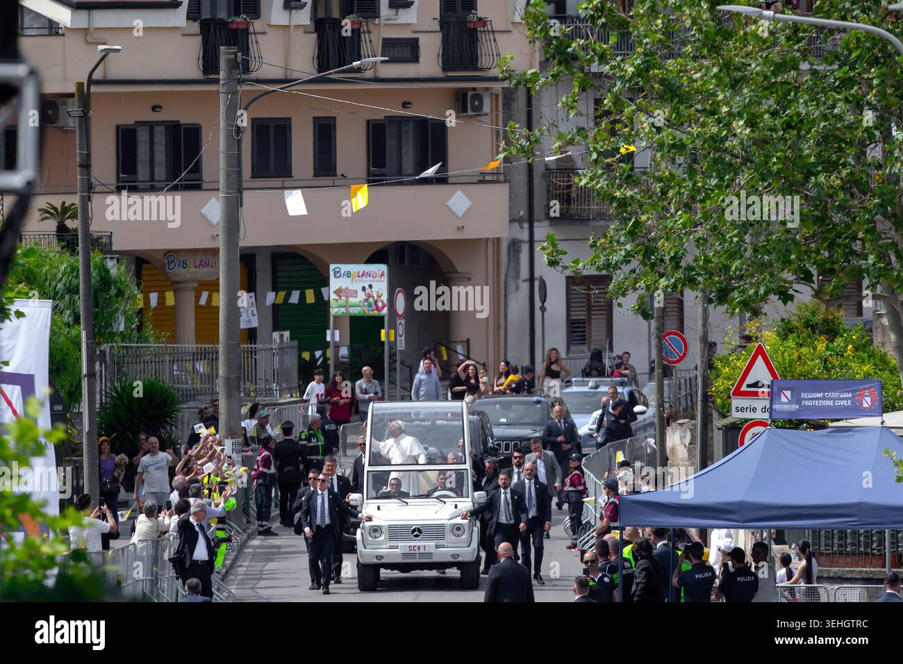 Pope Leo XIV waves as he arrives on the popemobile at Piazza Calipari ...