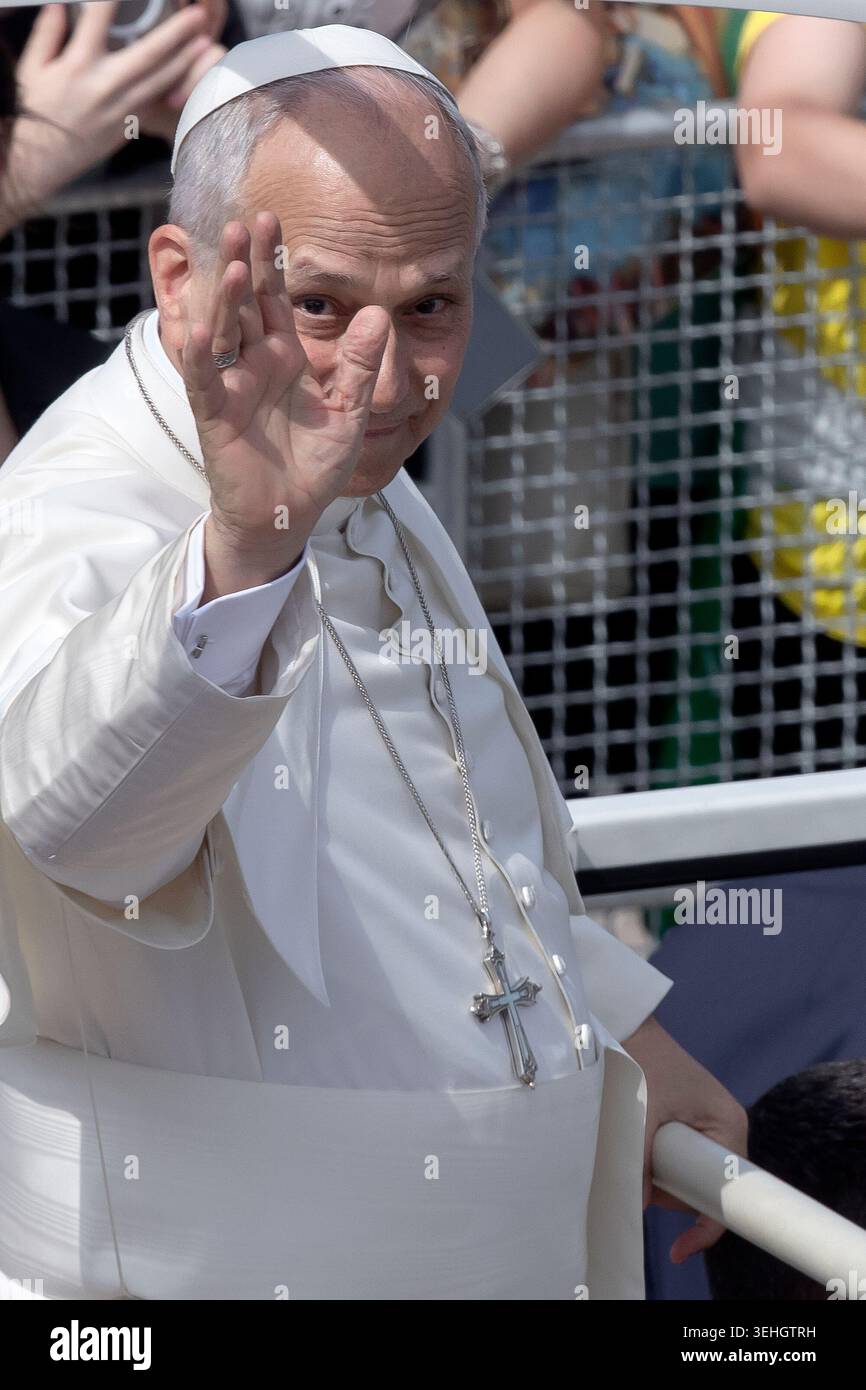 Pope Leo XIV waves as he arrives on the popemobile at Piazza Calipari ...