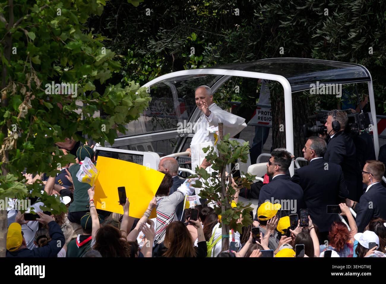 Pope Leo XIV waves as he arrives on the popemobile at Piazza Calipari ...