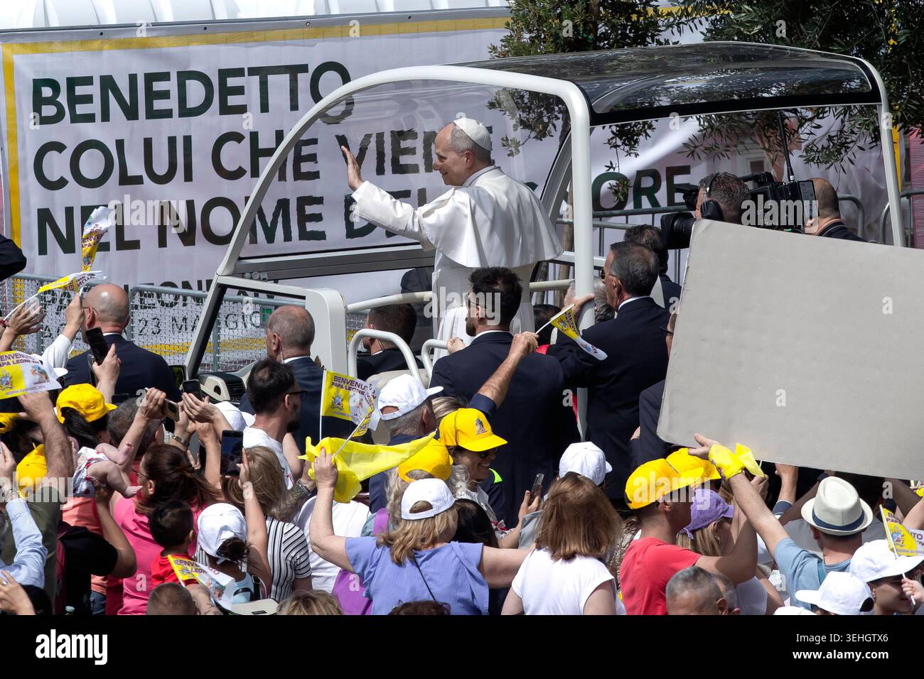 Pope Leo XIV waves as he arrives on the popemobile at Piazza Calipari ...
