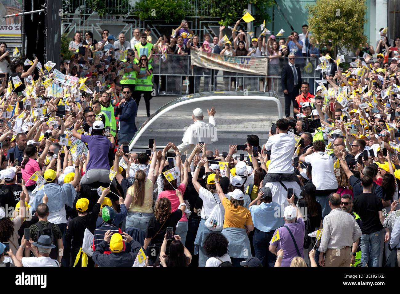 Pope Leo XIV waves as he arrives on the popemobile at Piazza Calipari ...