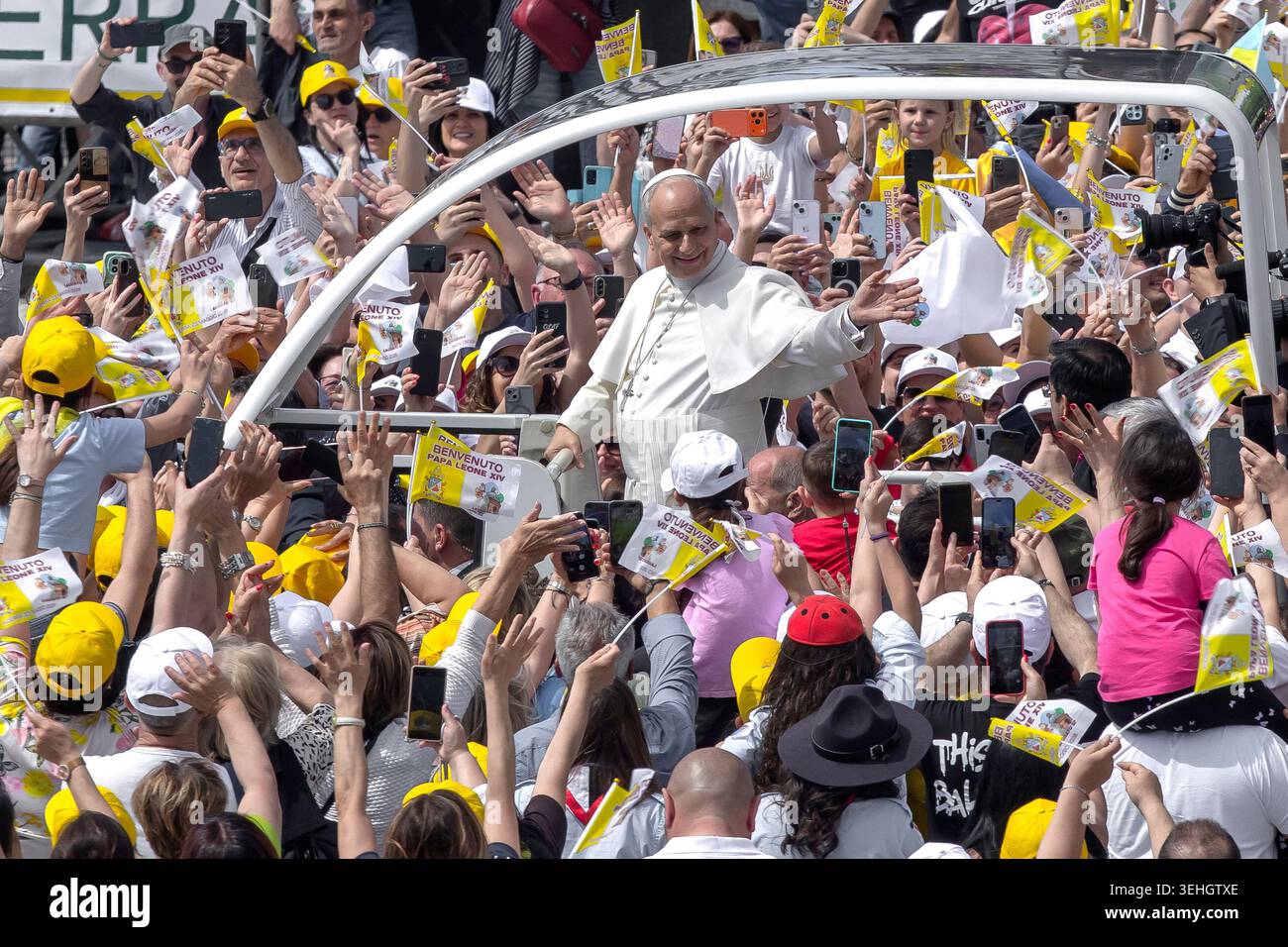 Pope Leo XIV waves as he arrives on the popemobile at Piazza Calipari ...