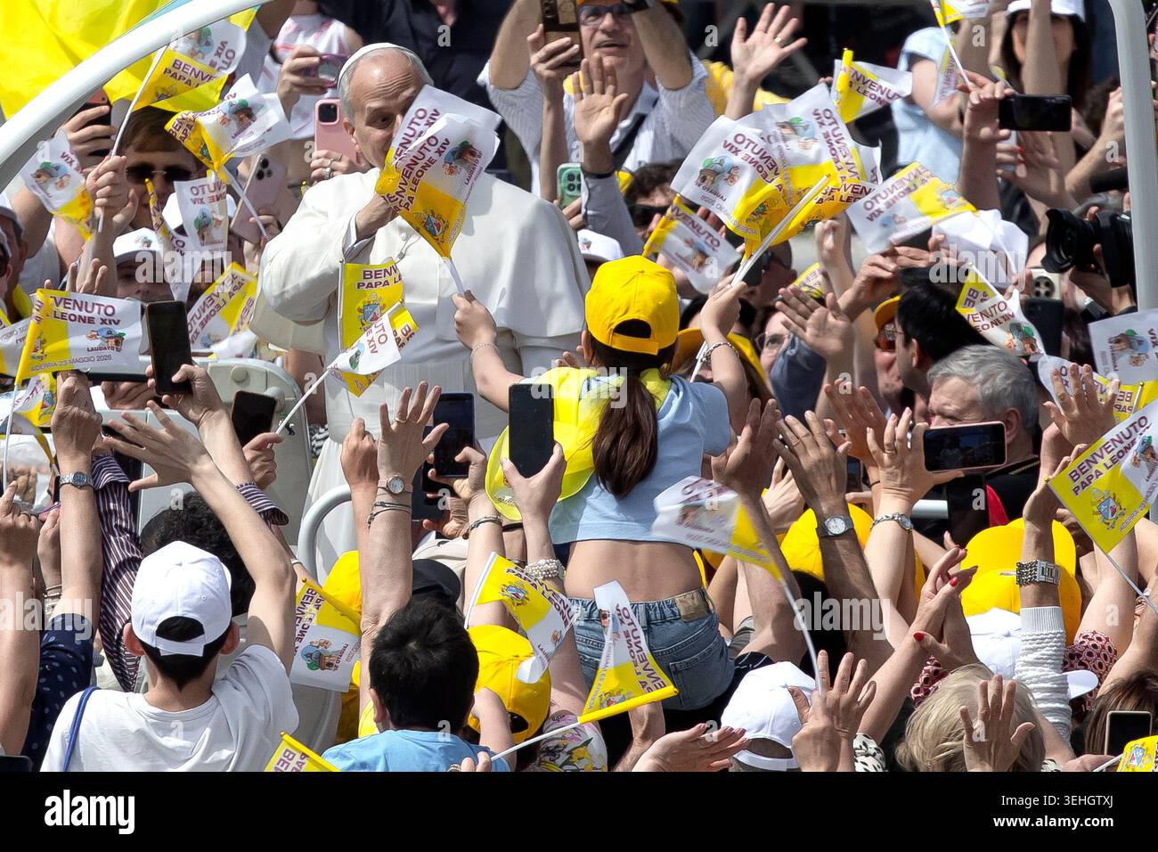 Pope Leo XIV waves as he arrives on the popemobile at Piazza Calipari ...