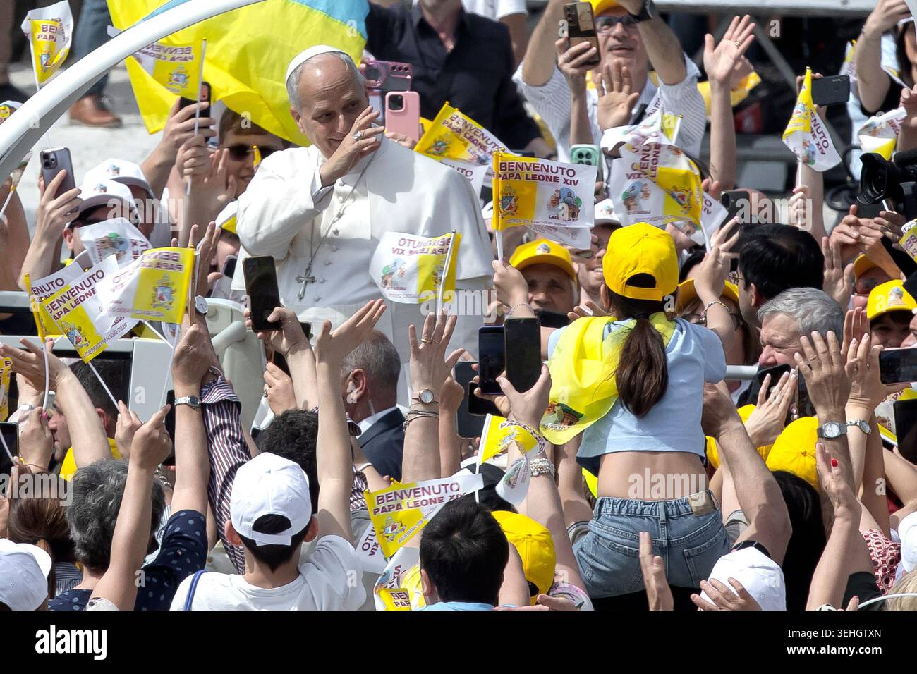 Pope Leo XIV waves as he arrives on the popemobile at Piazza Calipari ...