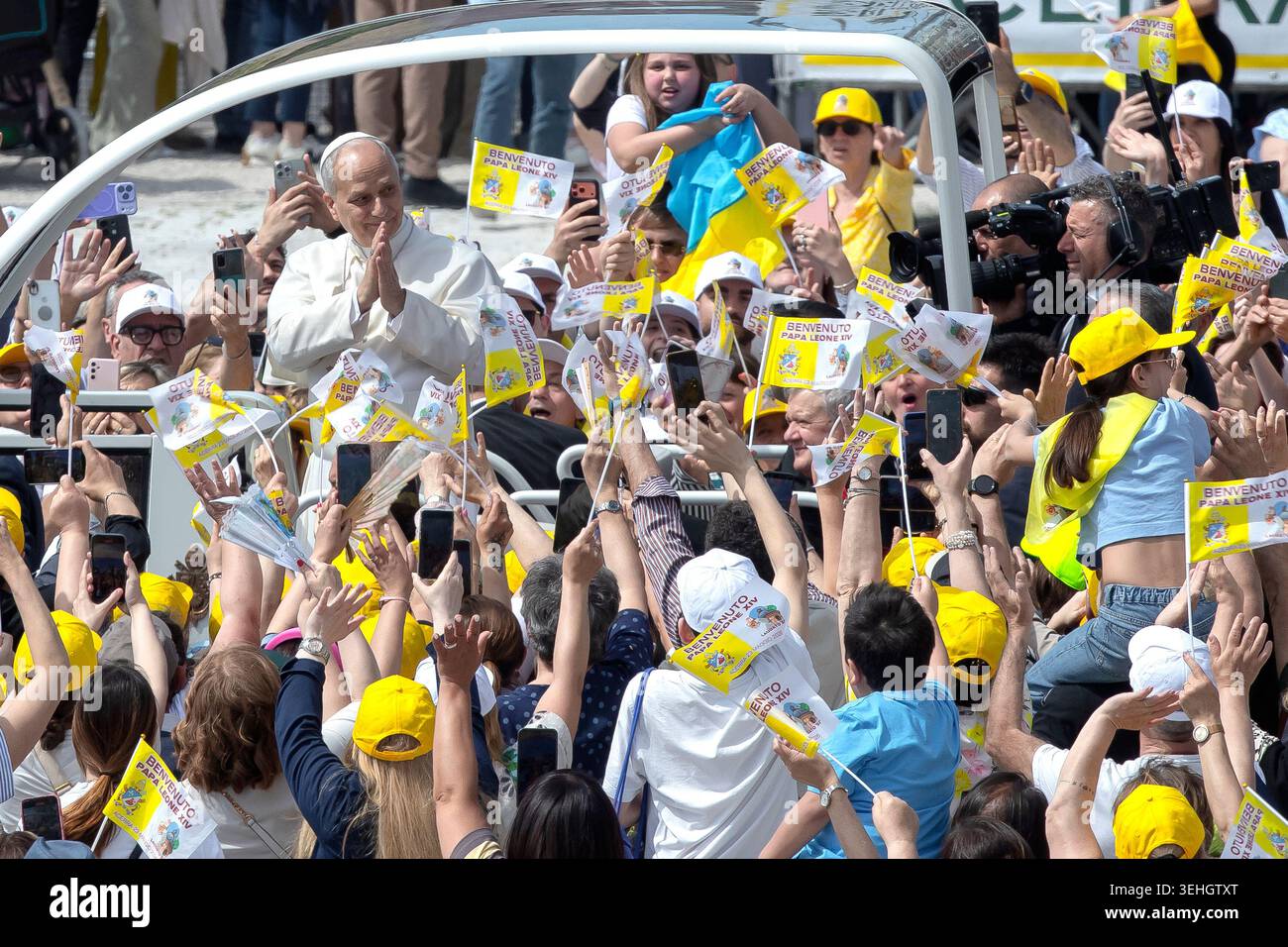 Pope Leo XIV waves as he arrives on the popemobile at Piazza Calipari ...