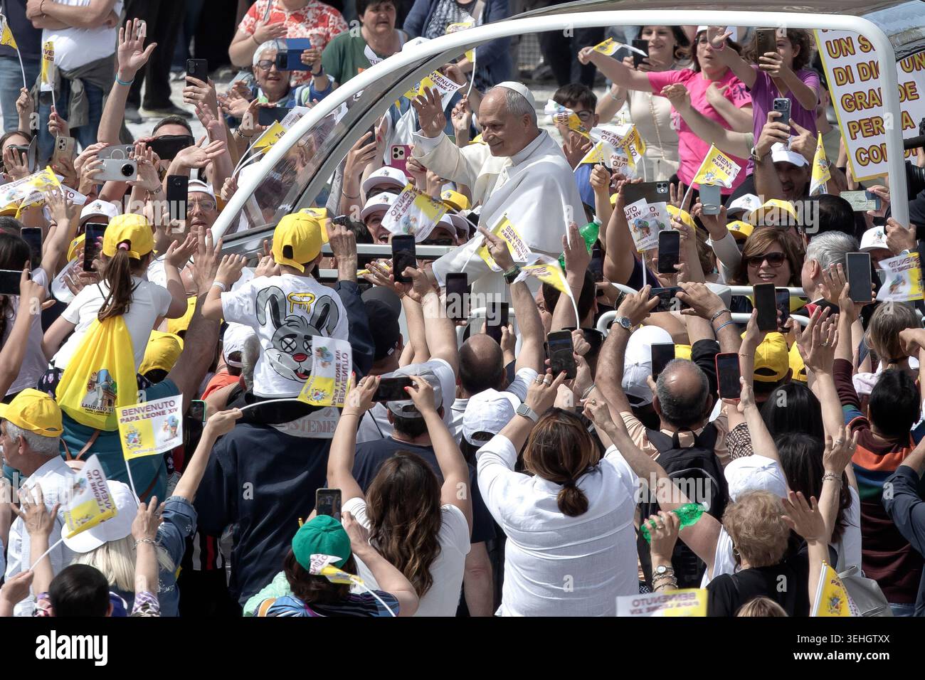Pope Leo XIV waves as he arrives on the popemobile at Piazza Calipari ...