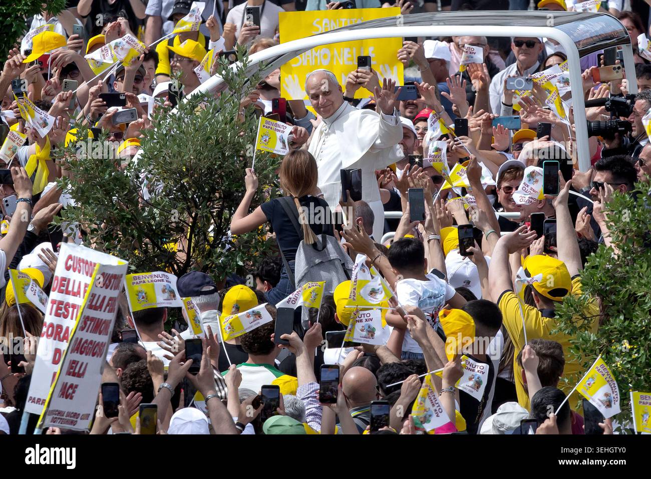Pope Leo XIV waves as he arrives on the popemobile at Piazza Calipari ...