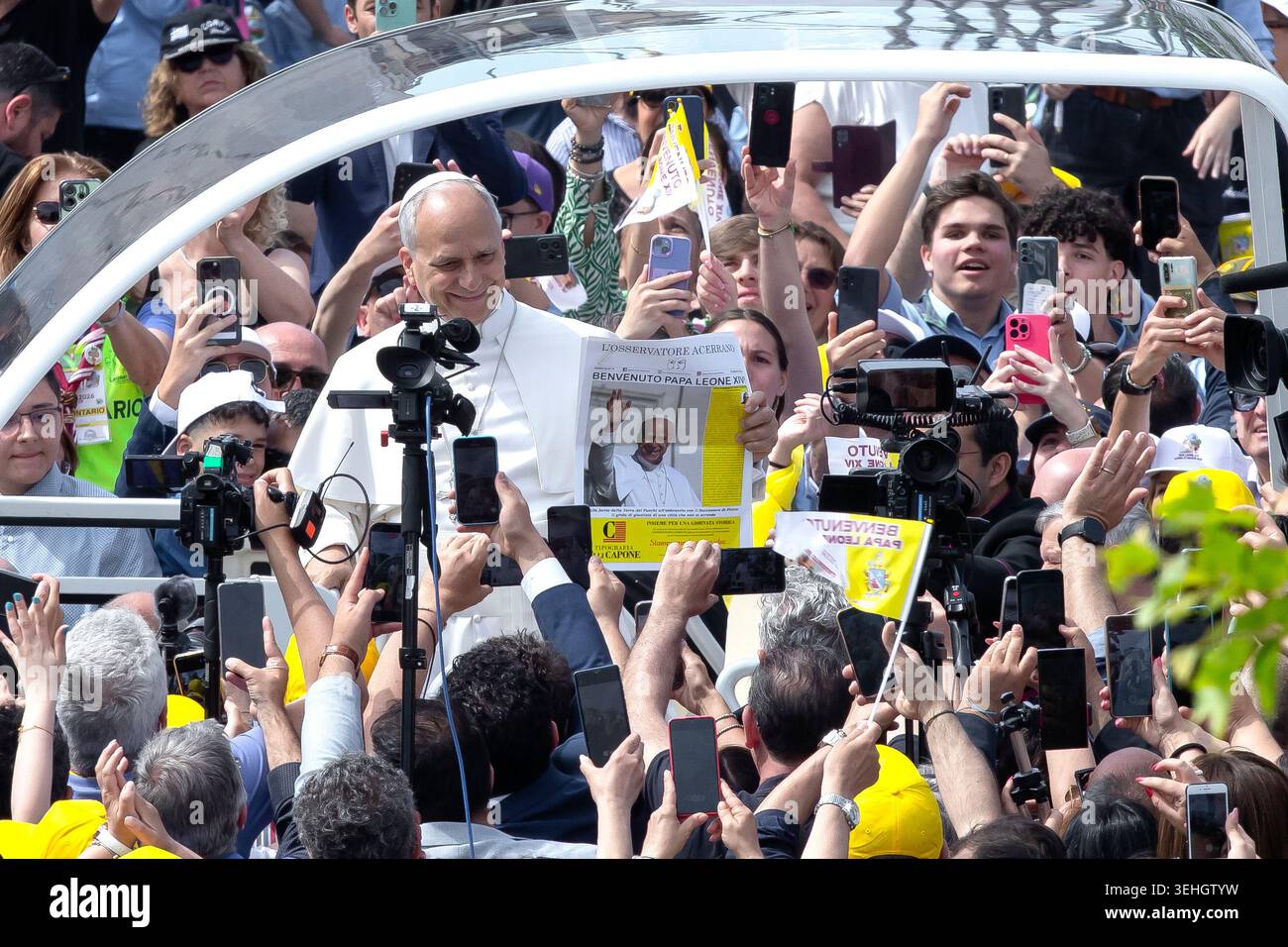Pope Leo XIV waves as he arrives on the popemobile at Piazza Calipari ...
