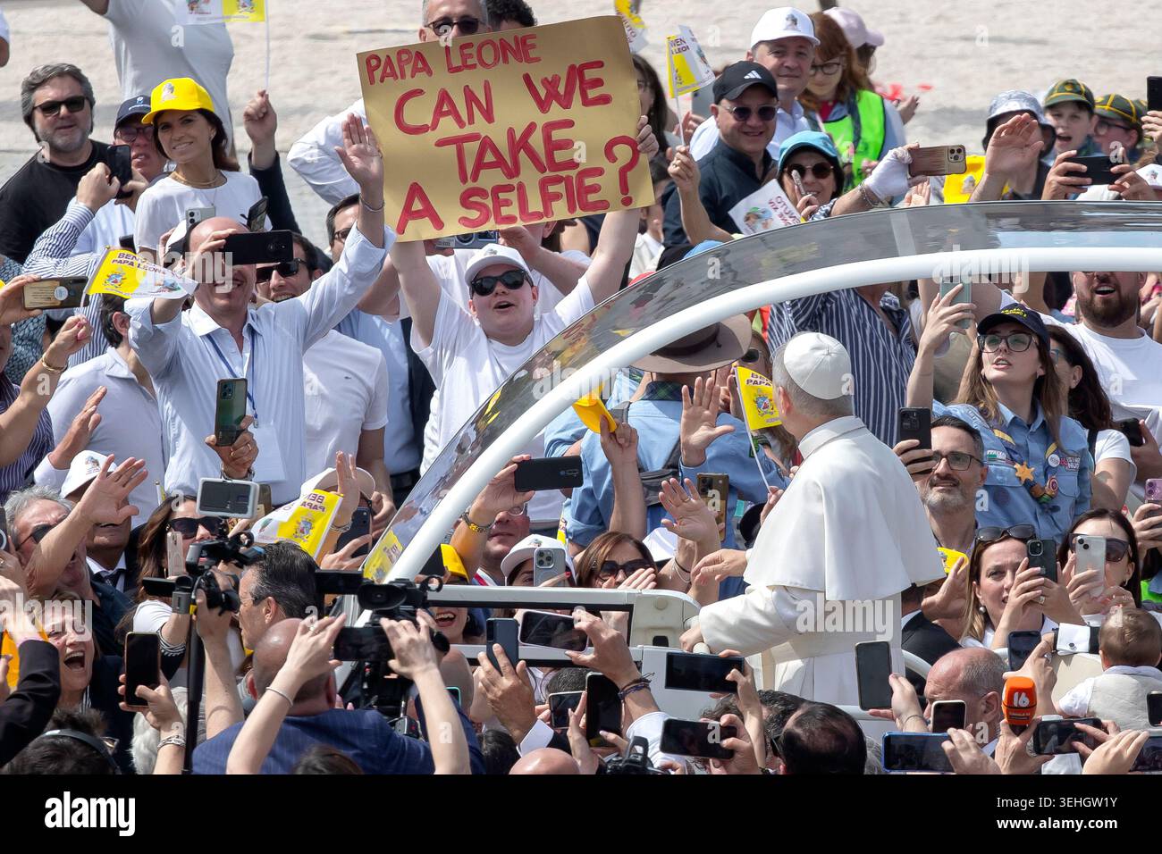 Pope Leo XIV waves as he arrives on the popemobile at Piazza Calipari ...