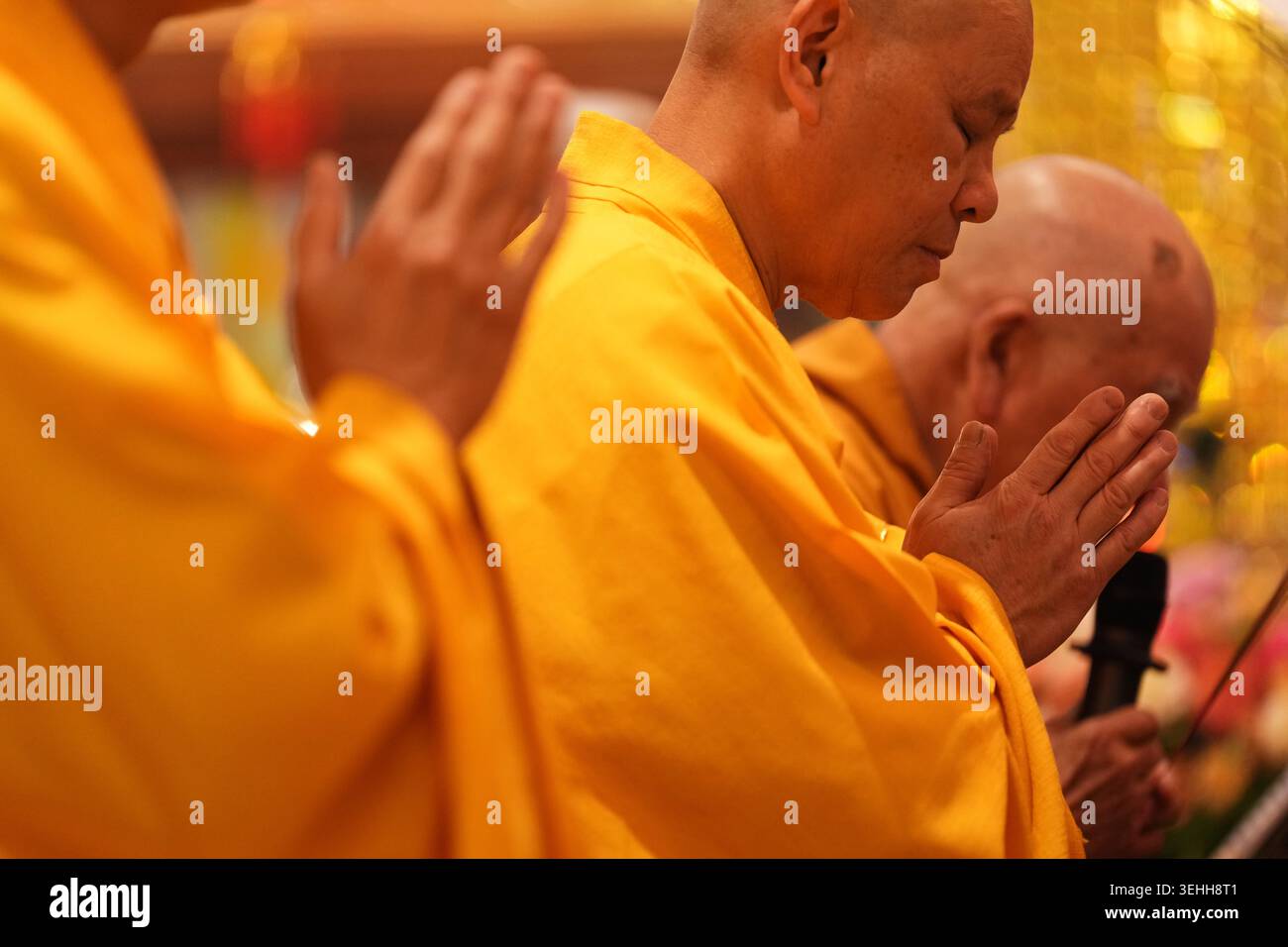 Monks pray during a midday offering to the Buddha at the main shrine ...