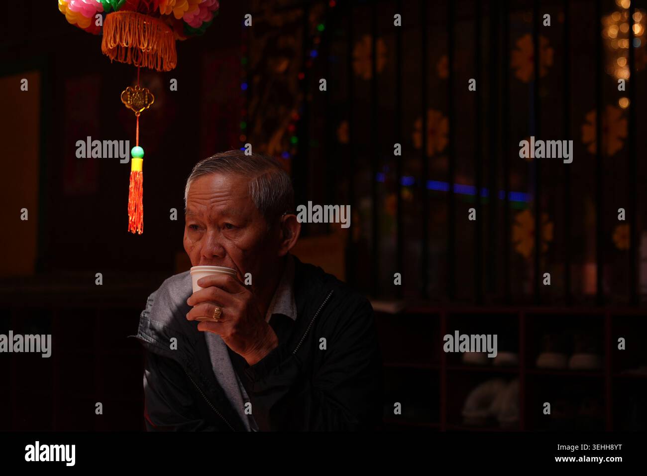 An attendee sips tea during a celebration of Buddha's birthday at ...