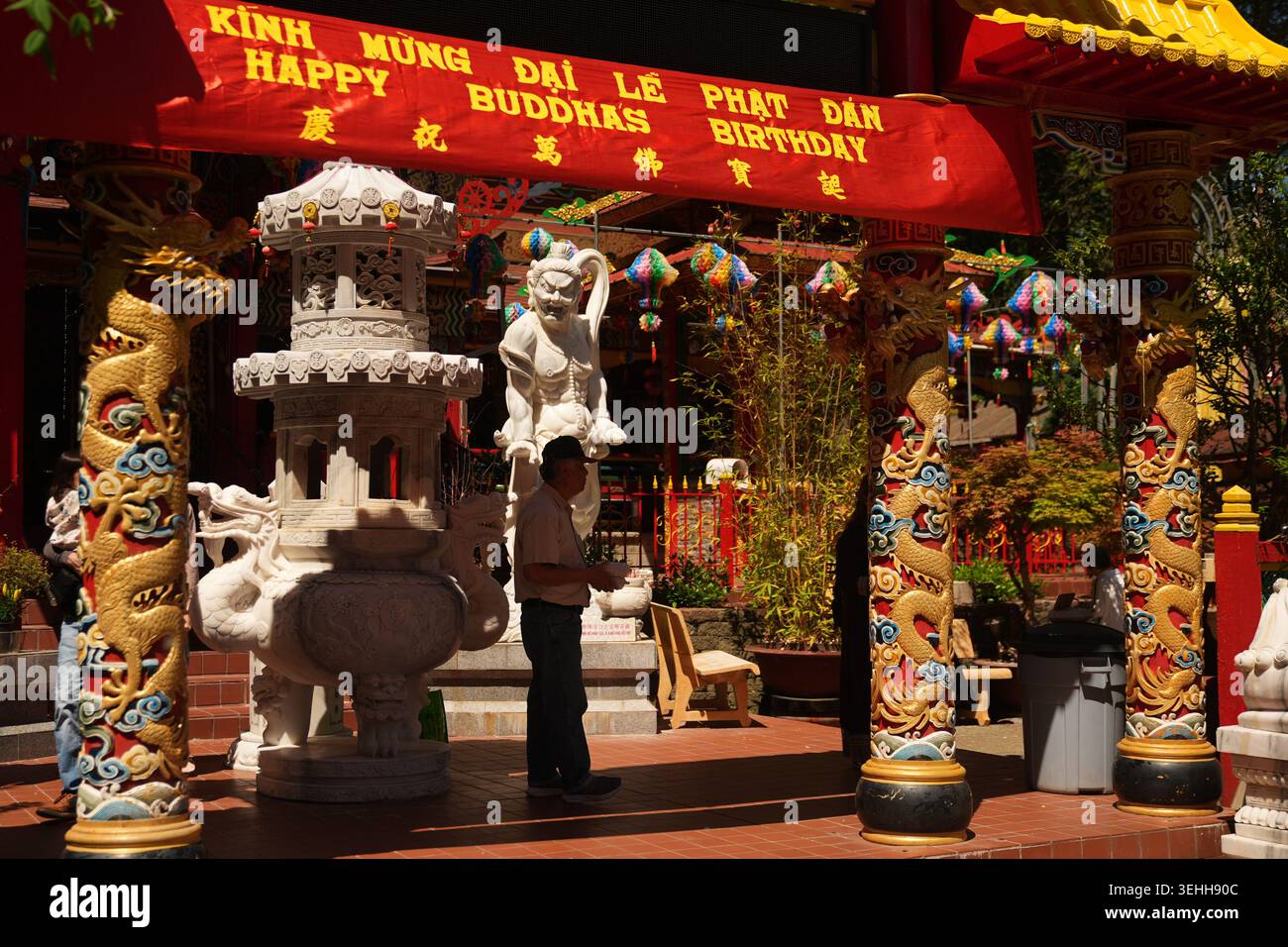 People walk by a banner adorning the entrance to Ksitigarbha Temple ...
