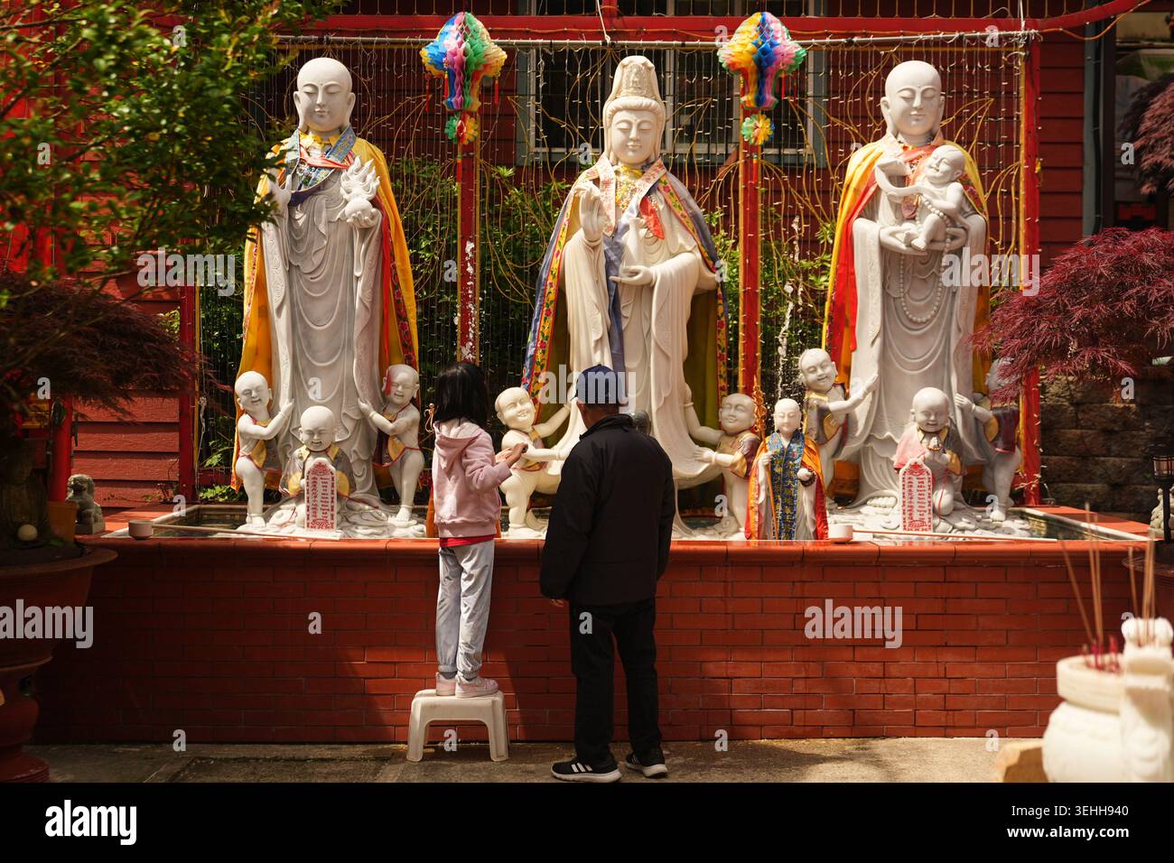 People bathe Ksitigarbha statues outside the main shrine during a ...