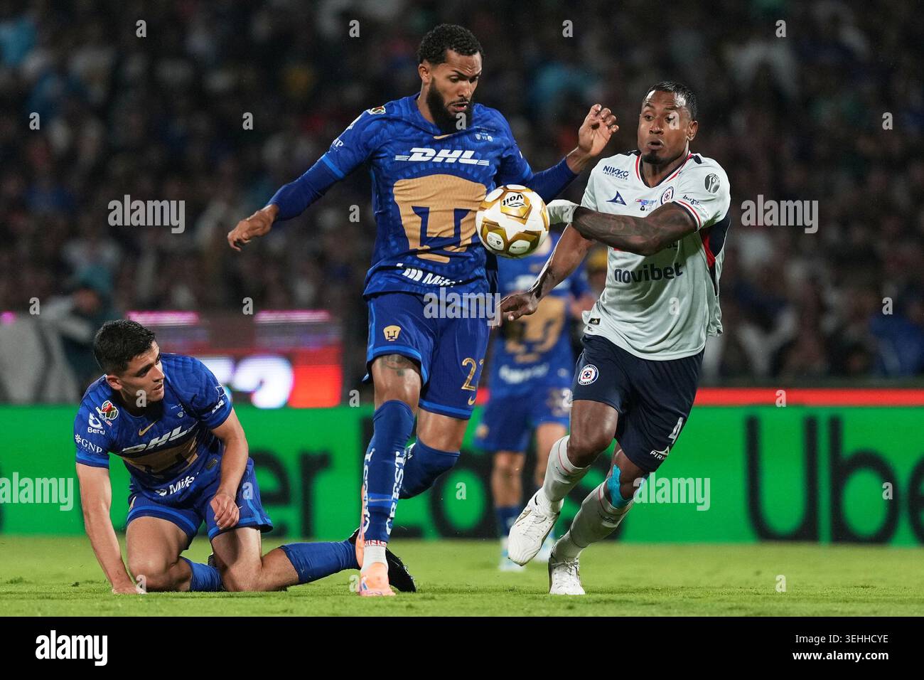 Pumas' Juninho, center, and Cruz Azul's Willer Ditta go for the ball ...