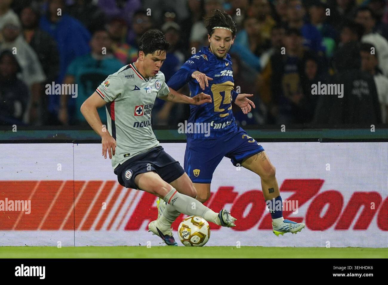 Cruz Azul's Amaury Garcia, left, and Pumas' Jordan Carillo compete for ...
