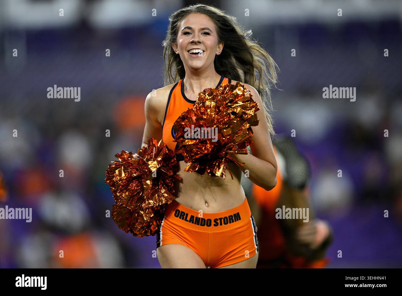 An Orlando Storm cheerleader runs off of the field after performing ...