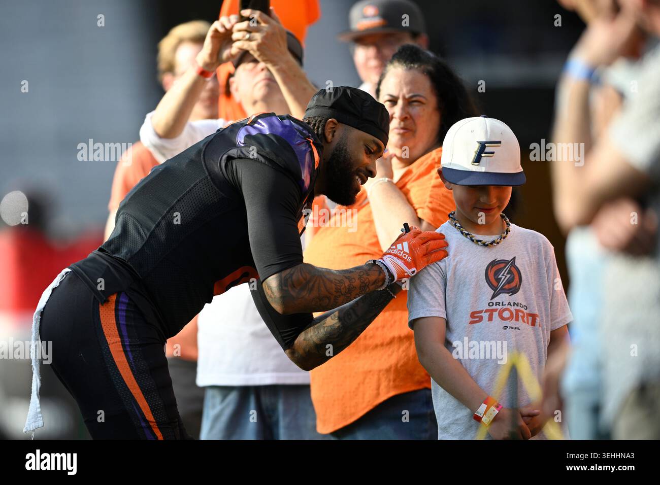 Orlando Storm cornerback Mark Gilbert, left, signs an autograph for a ...