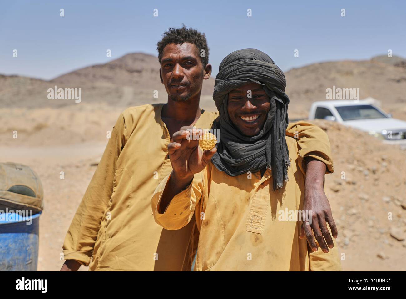 Miner Atta al-Khazin, right, shows a gold nugget produced by artisanal ...