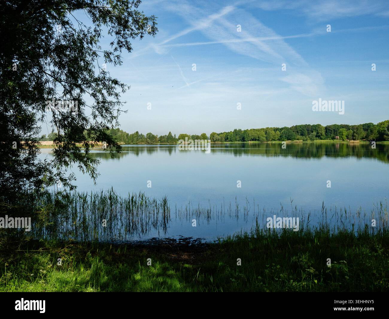 A view of a lake under blue skies. The Netherlands is finishing a sunny ...