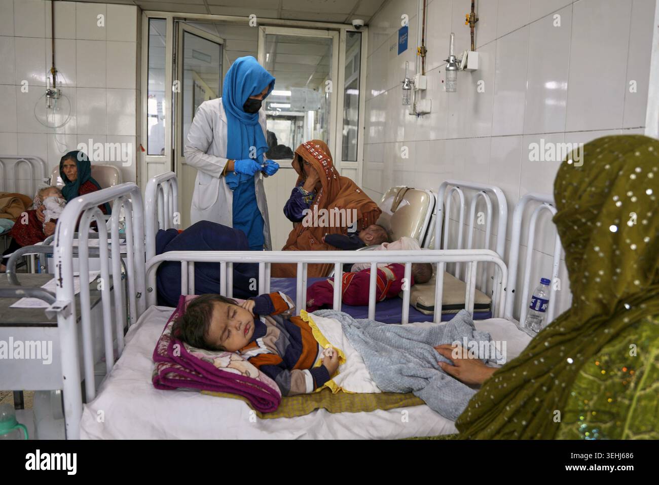 FILE.- Afghan women care for their children in the malnutrition ward at ...