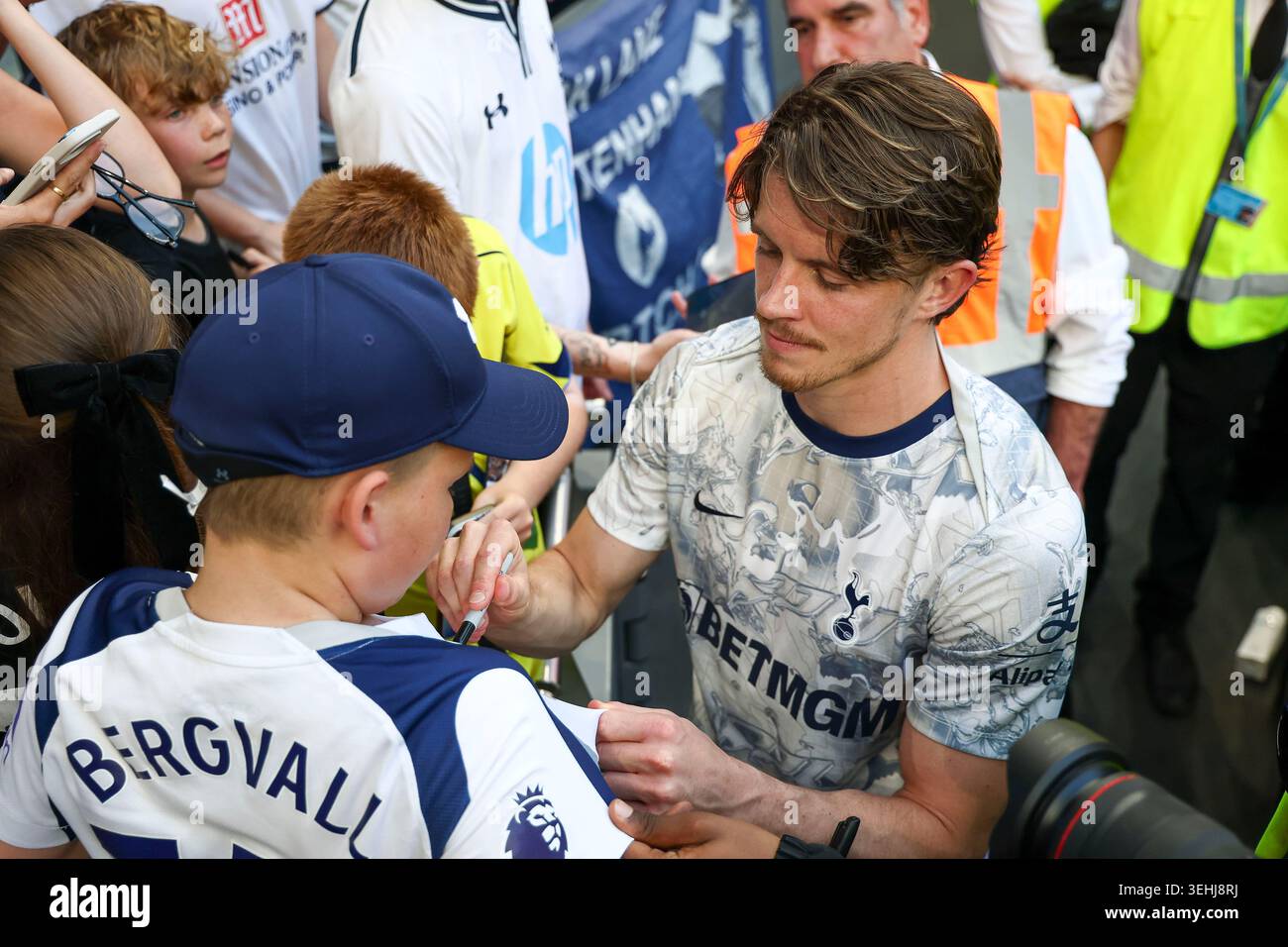 Conor Gallagher of Tottenham Hotspur signs a fan’s shirt after the ...