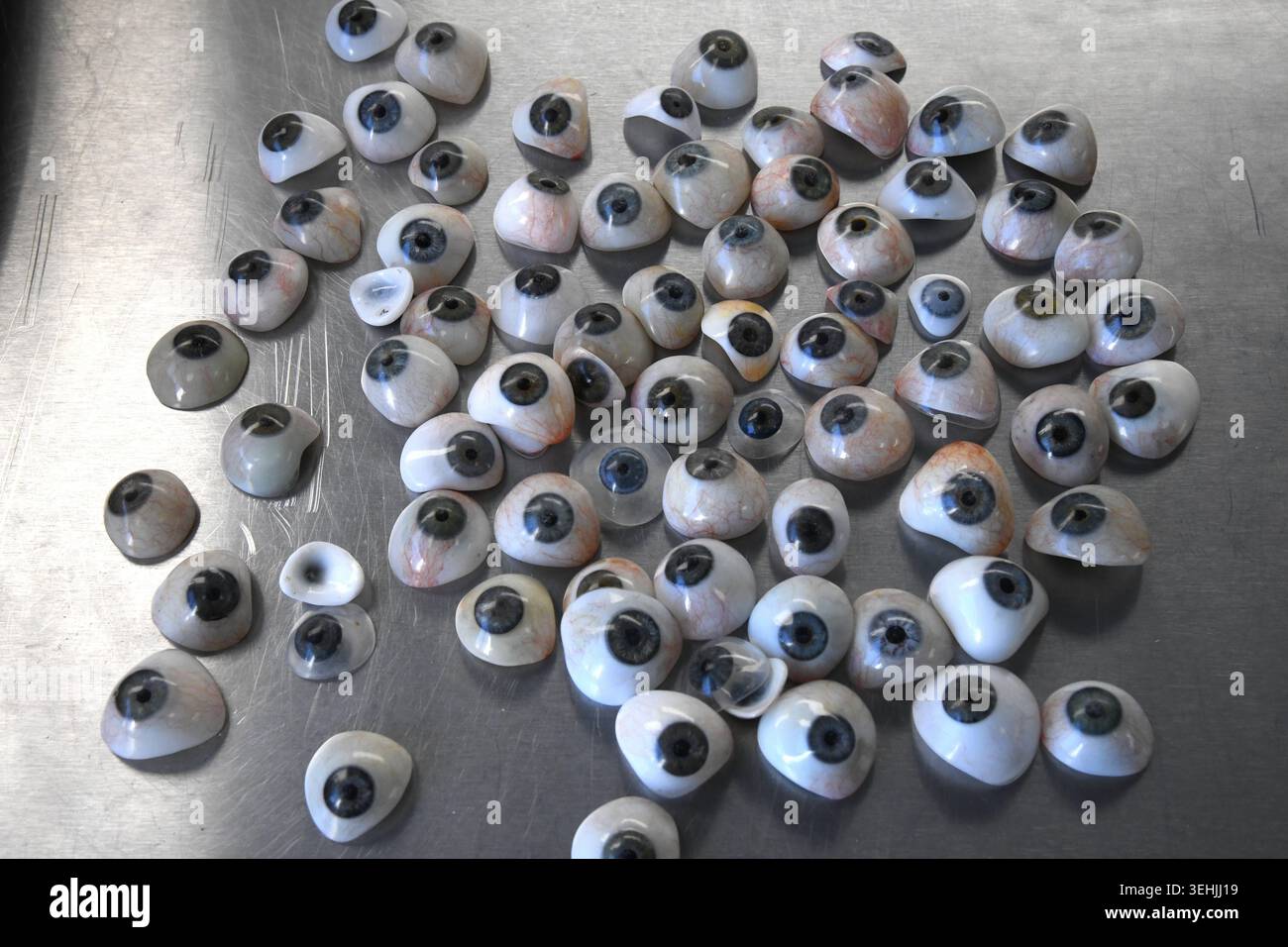 Numerous prosthetic eyes of varying sizes, colors, and shapes are ...