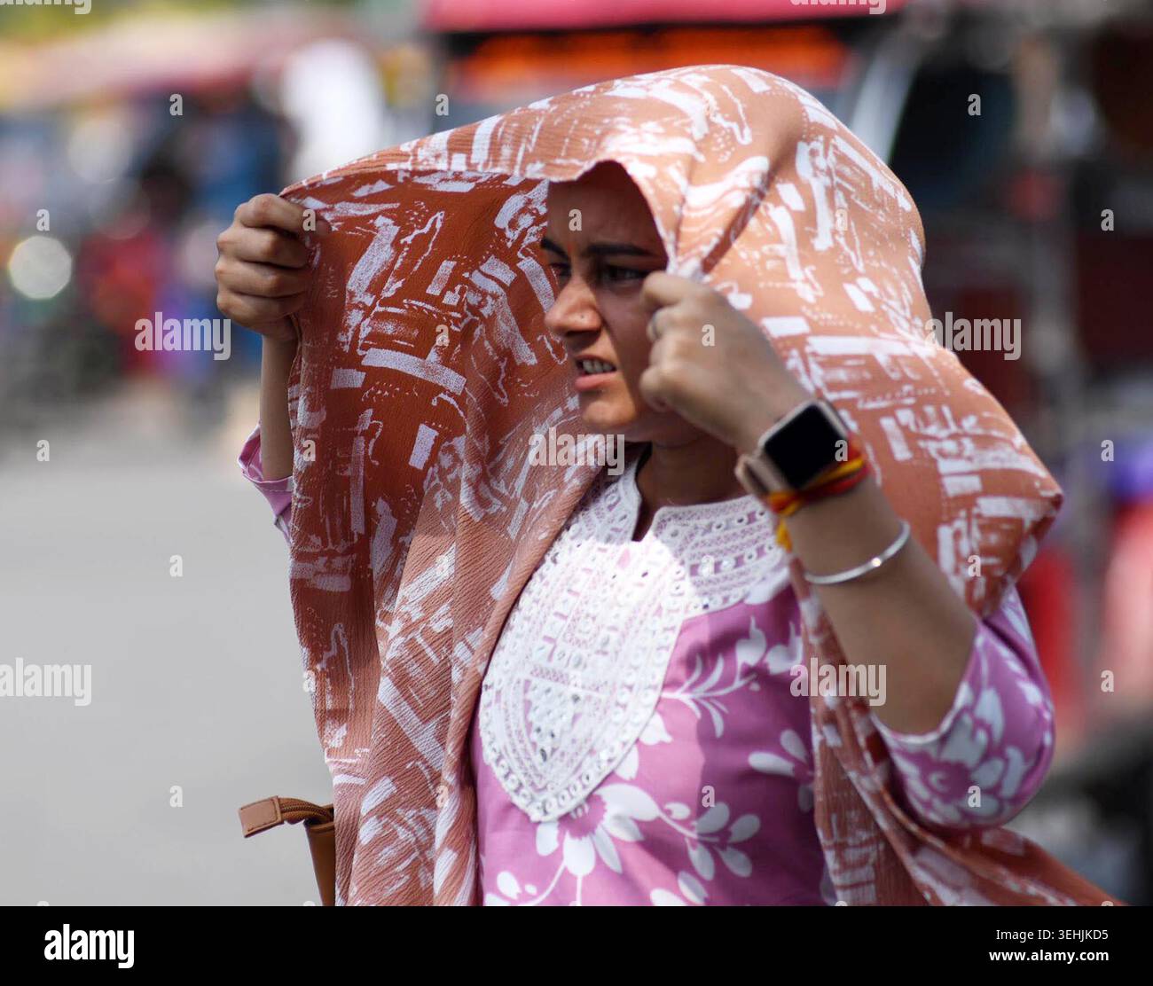 PATNA, INDIA - MAY 23: A Girl covering her face during a hot summer day ...