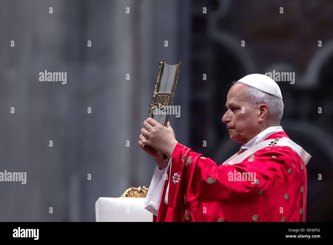 Pope Leo XIV holds the gospel during a Mass for the Solemnity of ...