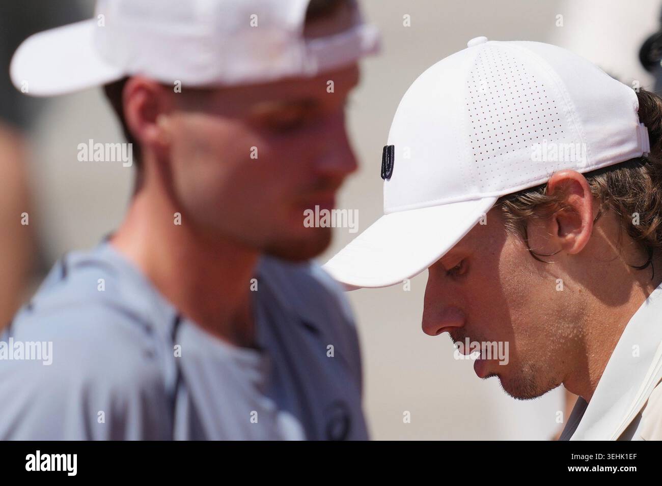 Alex De Minaur of Australia, right, and Toby Samuel of Britain walk ...