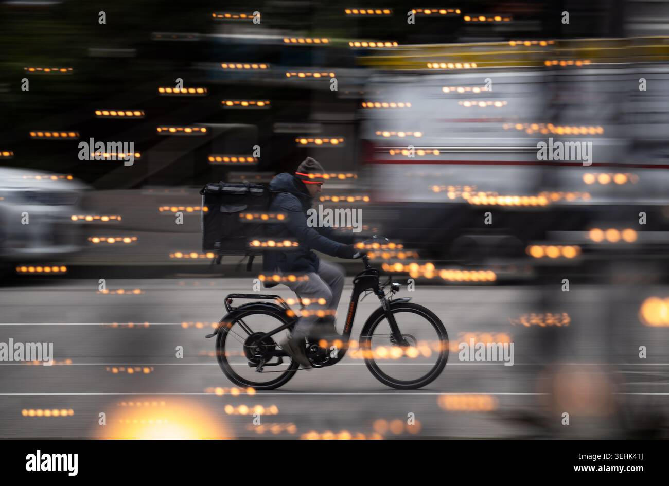 A food delivery worker rides a bike in downtown Vancouver, on Thursday ...